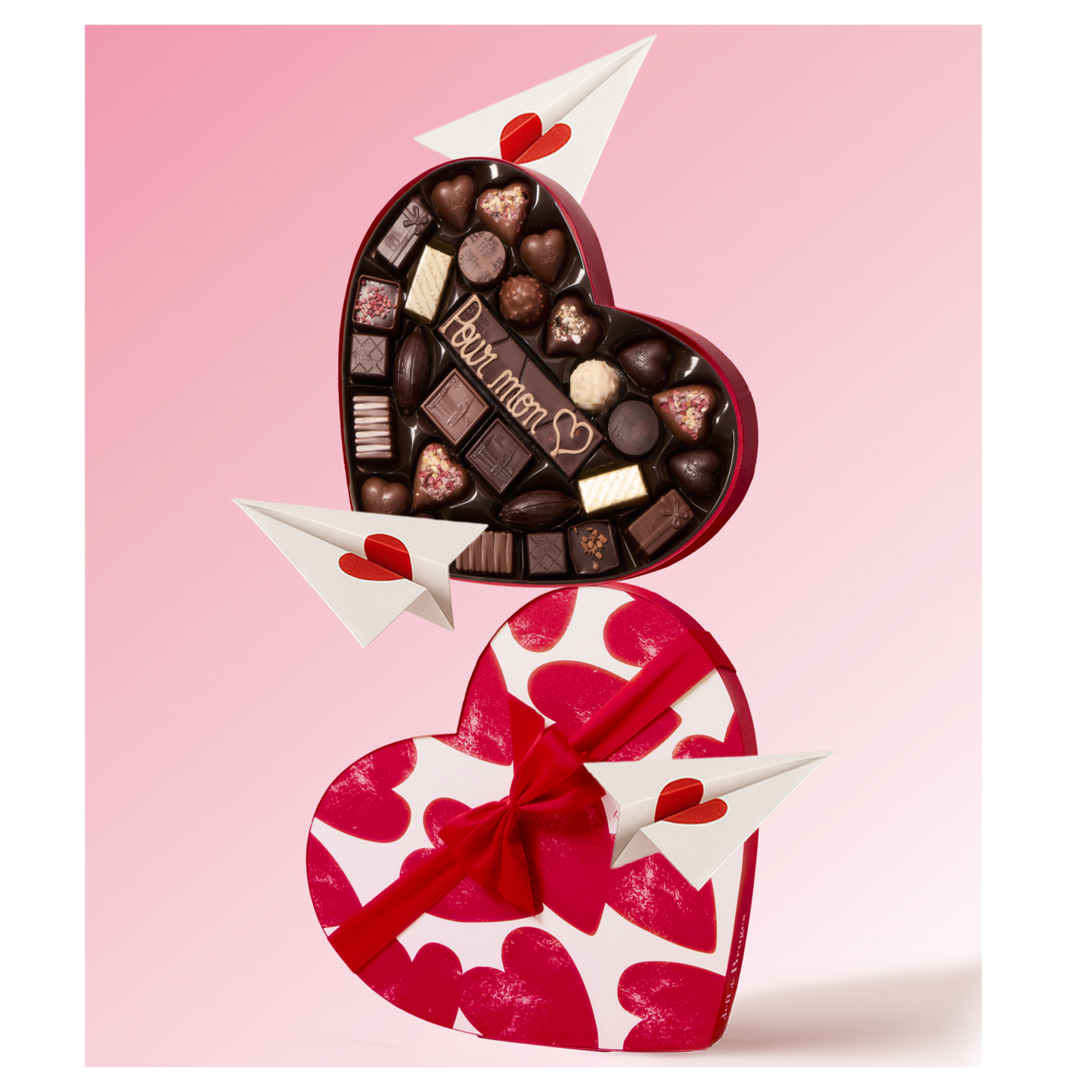 White heart-shaped box of Valentine's Day chocolates with dark ...